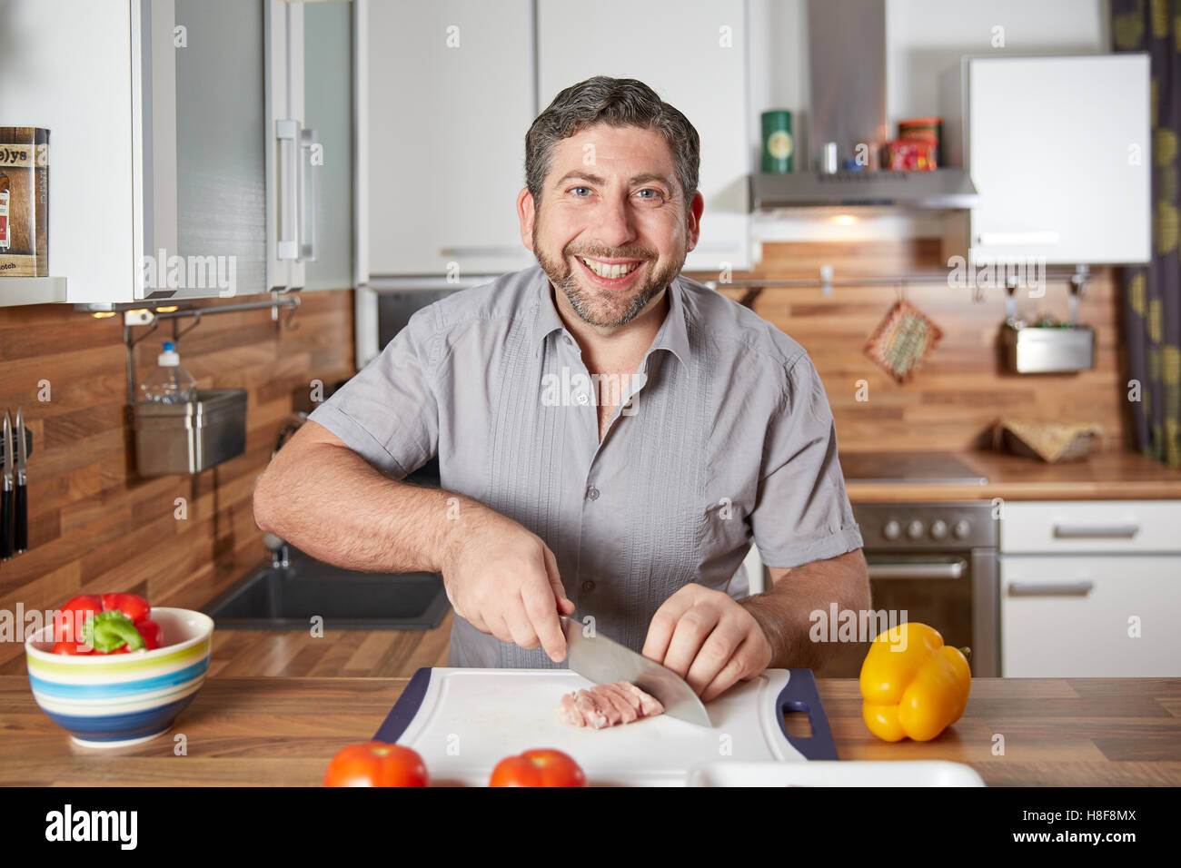 Young single handsome man preparing meal for cooking Stock Photo - Alamy