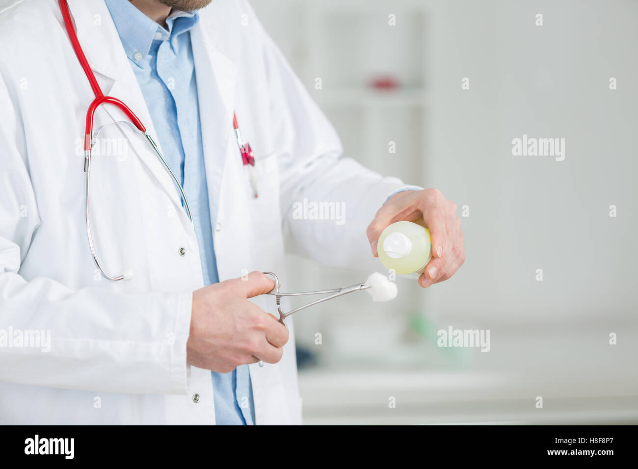 a medical doctor disinfecting pliers at the hospital Stock Photo - Alamy