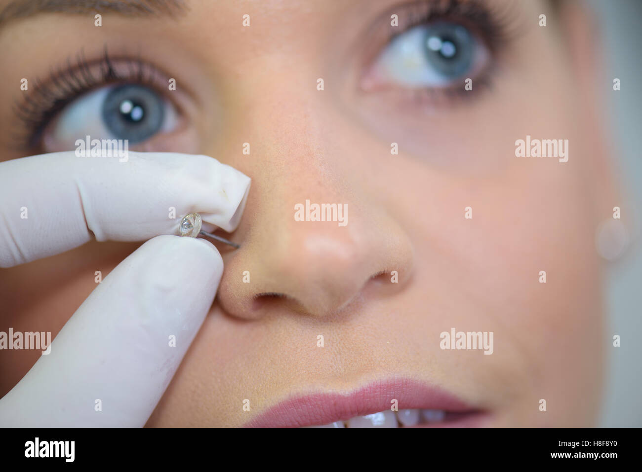 girl getting a piercing Stock Photo - Alamy