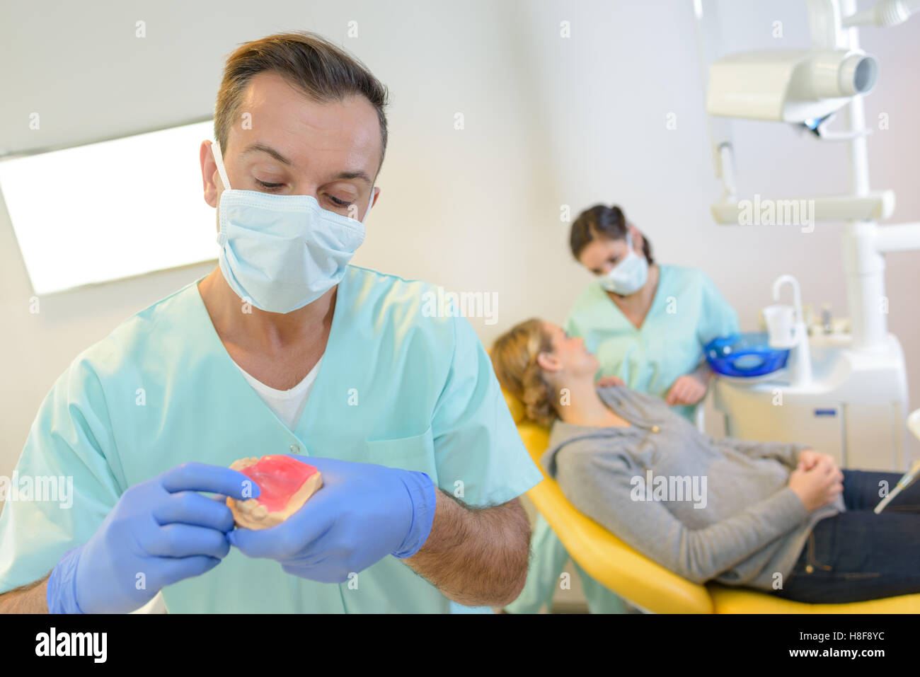 dentist curing a woman patient in the dental office Stock Photo - Alamy