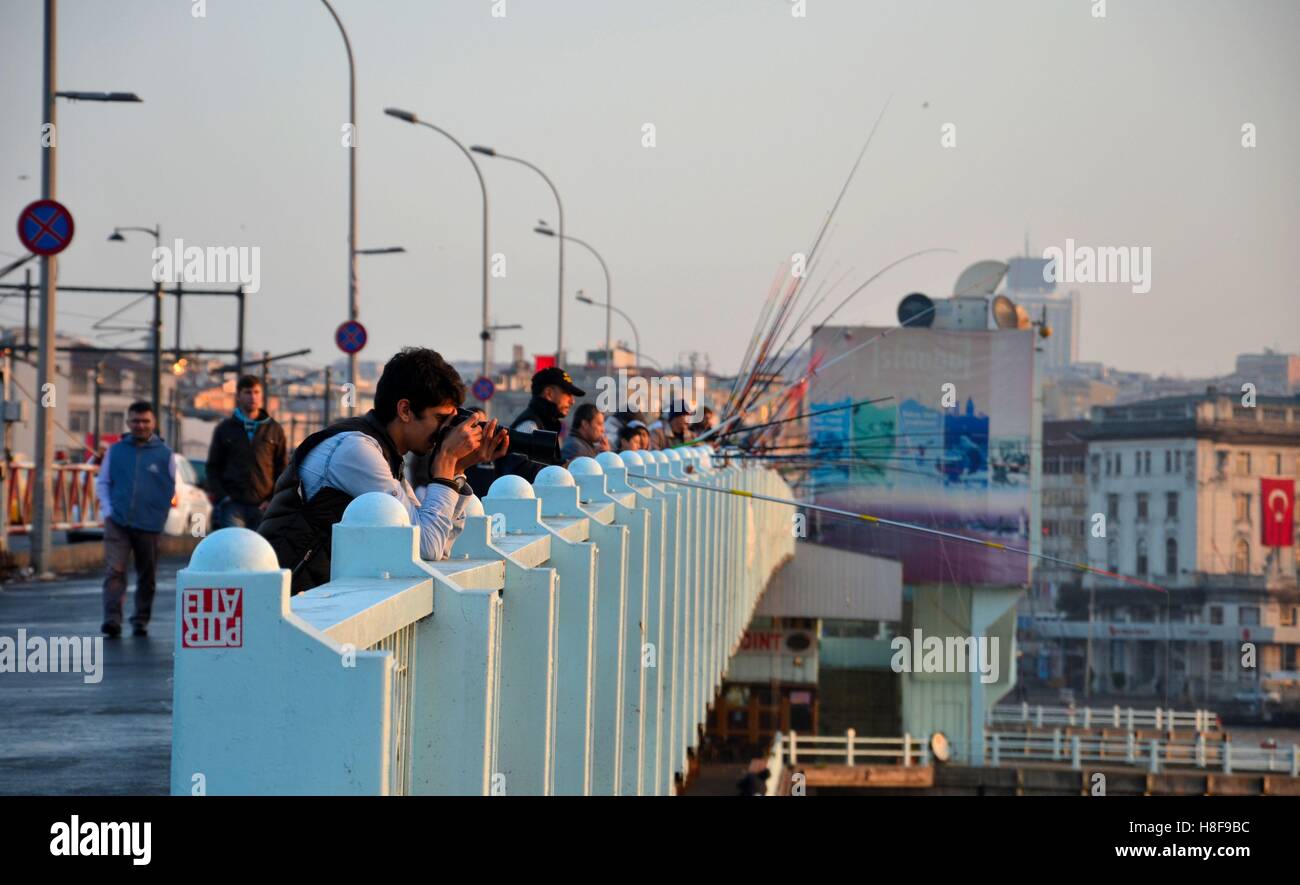 Photographer and people fishing from bridge crossing Bosphorus sea ...