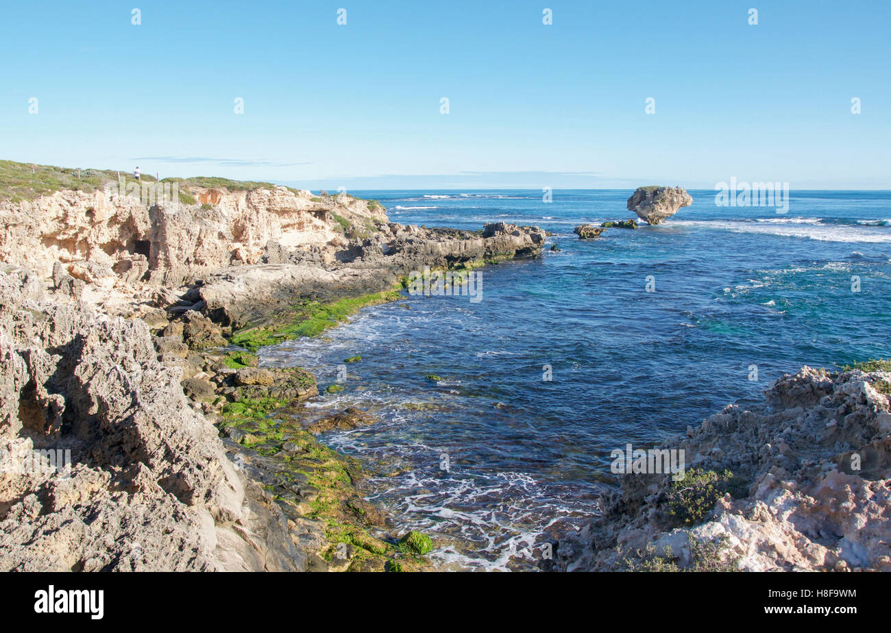 Rugged limestone bluff with the turquoise Indian Ocean seascape under a ...