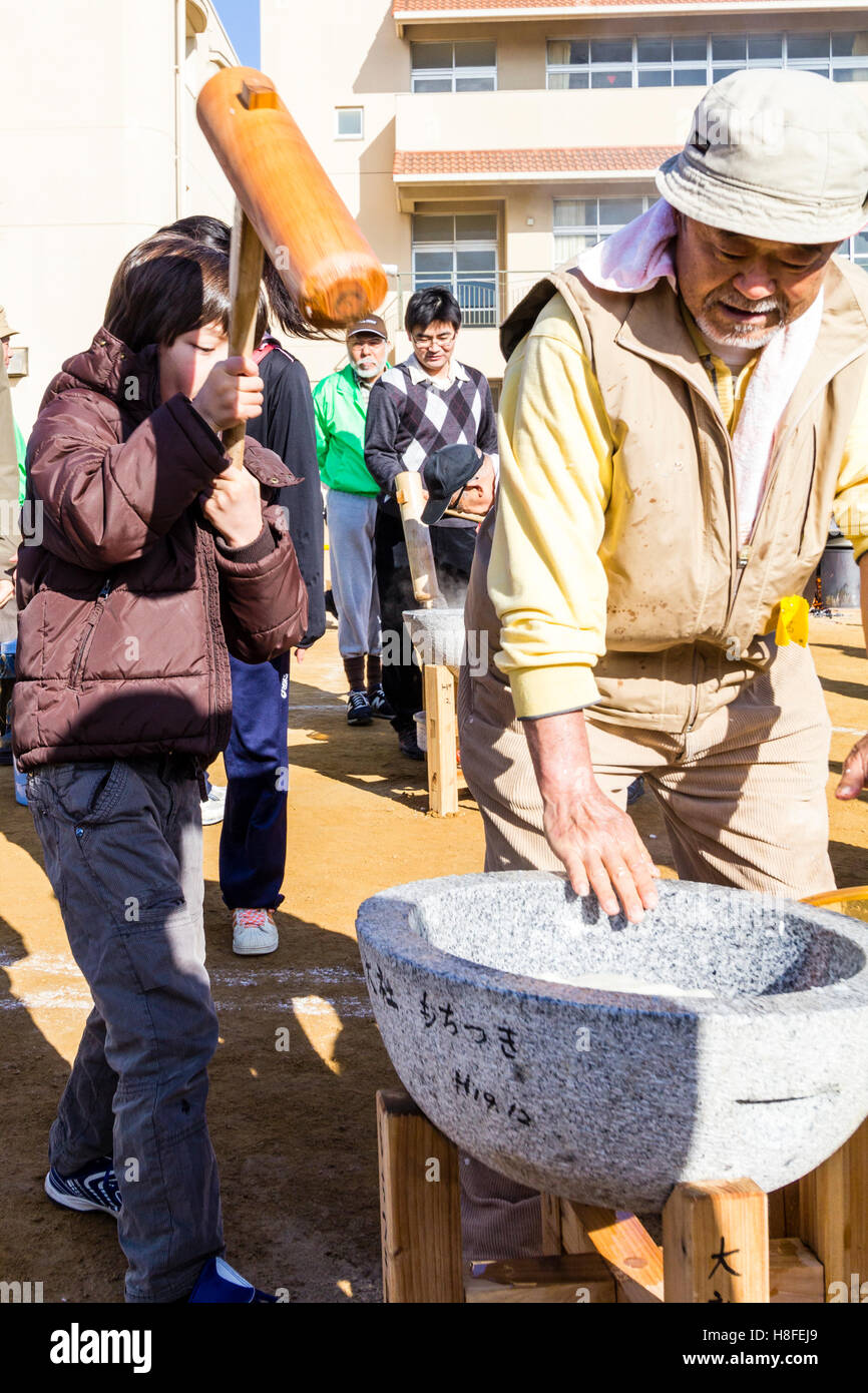 Japan. Omochi, winter rice bashing festival. Caucasian Child, boy, 7-8 ...