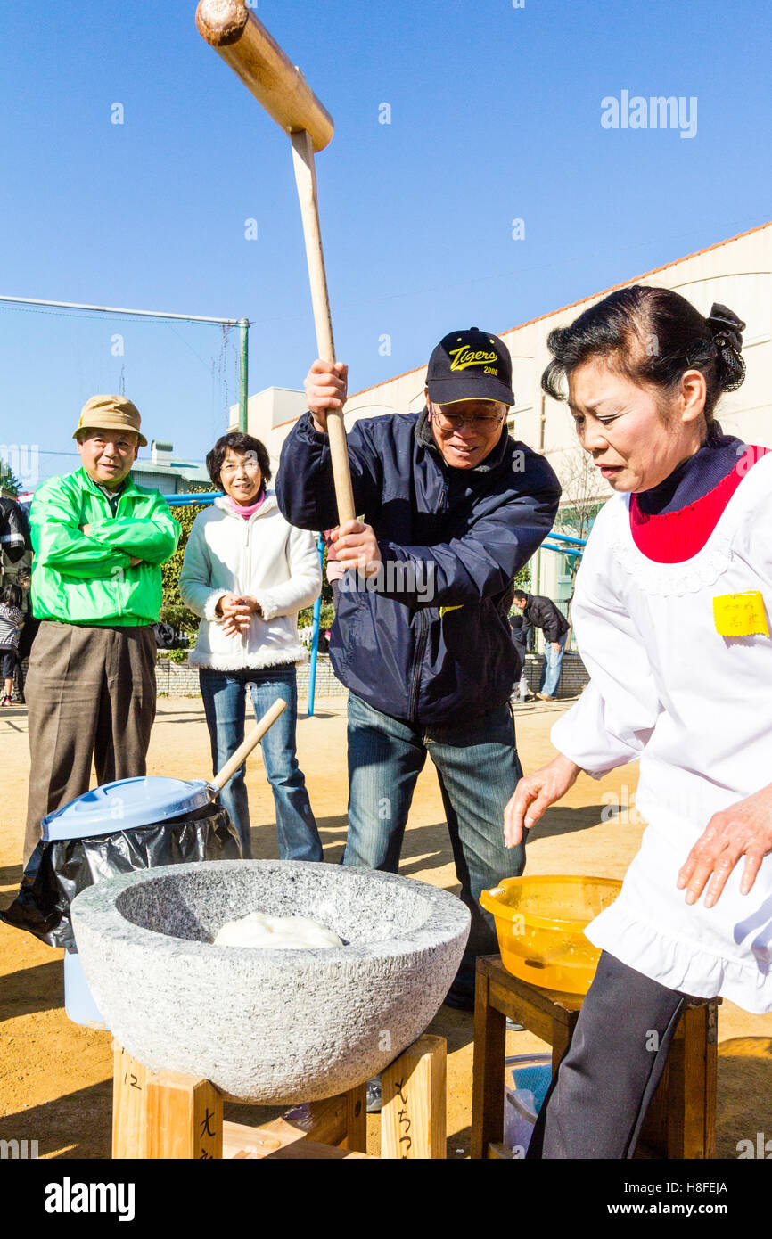 Japan. Omochi, winter rice bashing festival. Senior man holding with ...