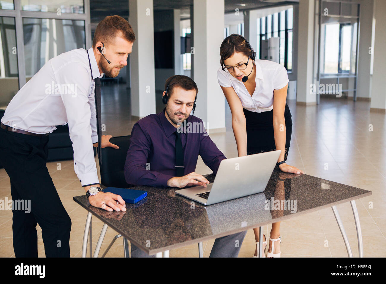 Sales assistants working with computers in an office Stock Photo - Alamy