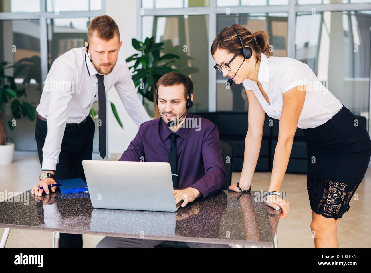 Sales assistants working with computers in an office Stock Photo - Alamy