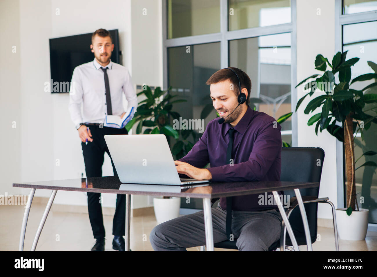 two man working in call center Stock Photo - Alamy