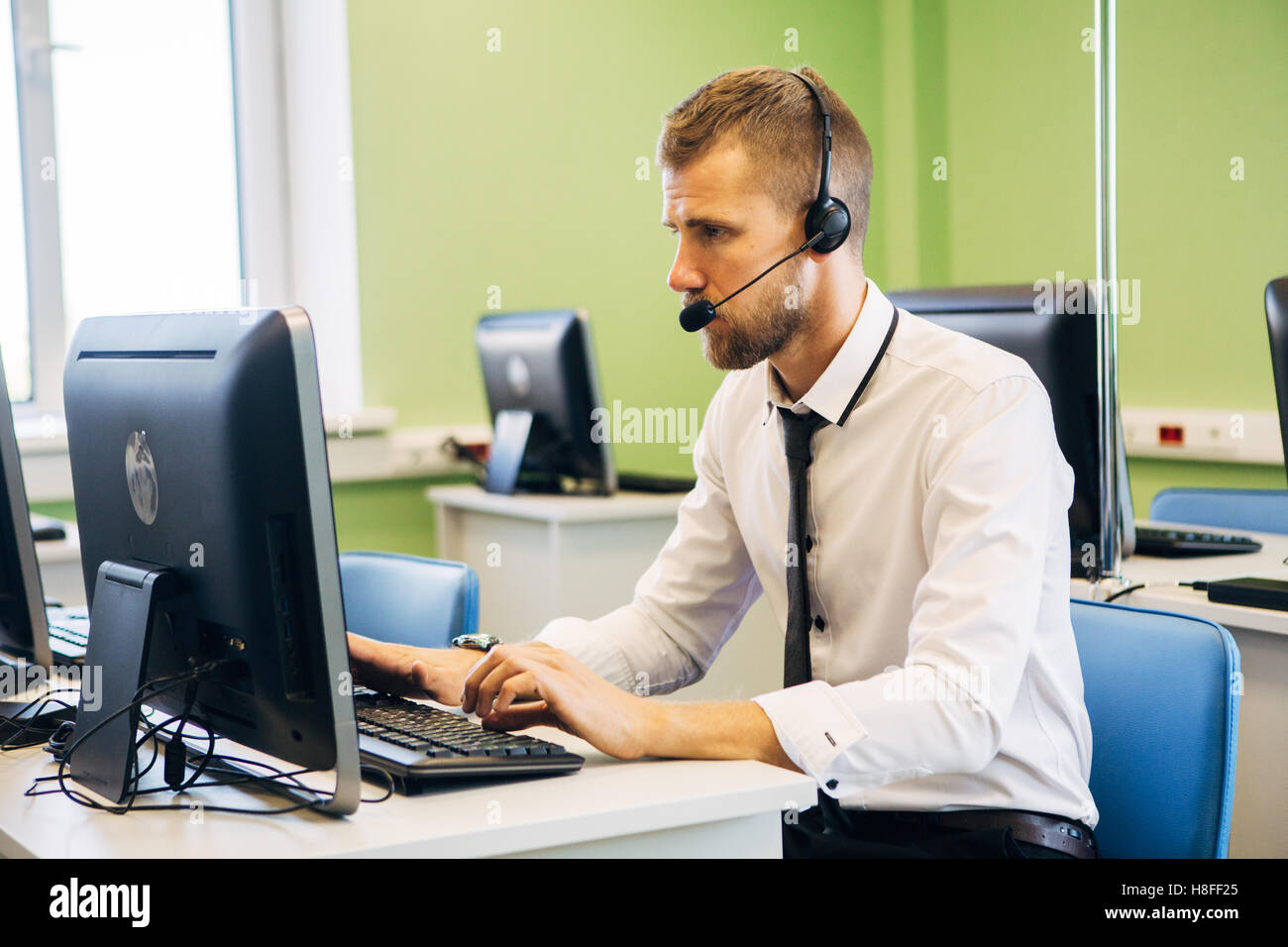 Smiling telephone agent with headset hi-res stock photography and ...