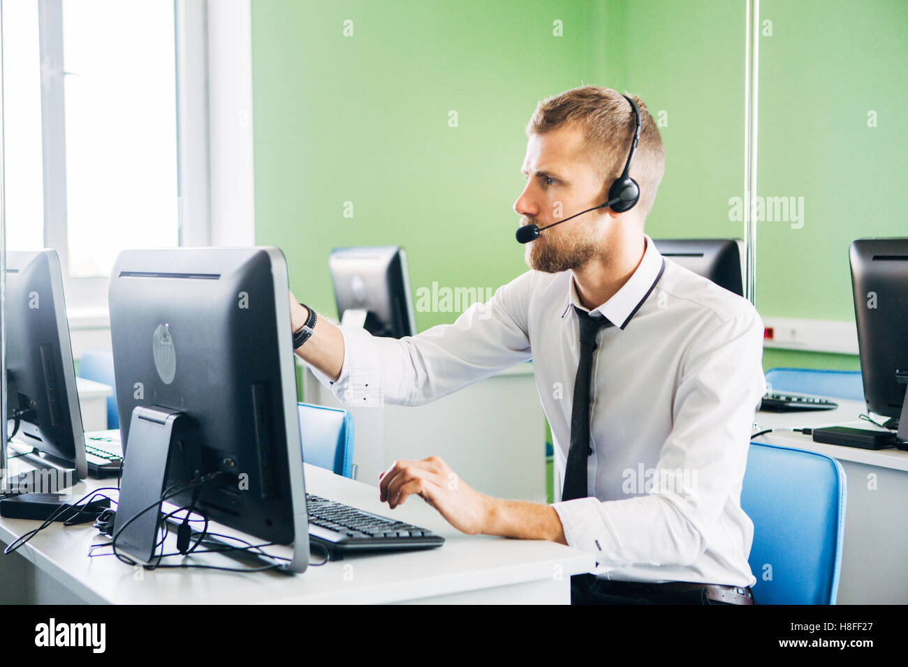 Smiling telephone agent with headset hi-res stock photography and ...