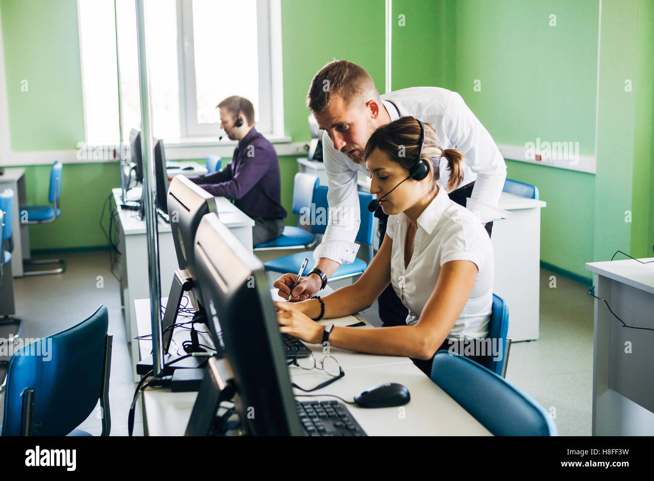 Call center operators at work Stock Photo - Alamy