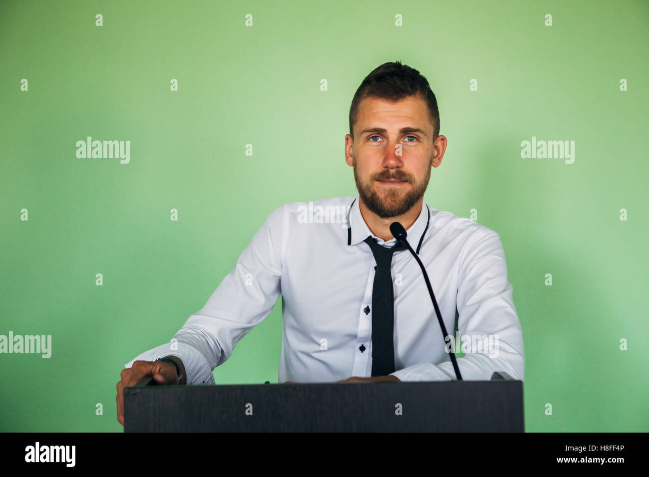 man talks on green background Stock Photo - Alamy