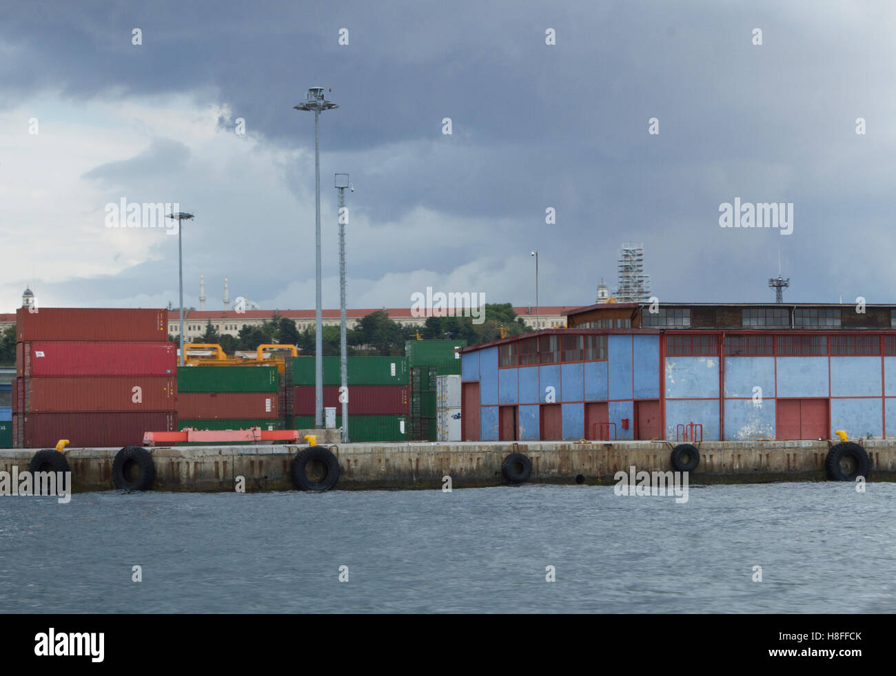 Seaport containers warehouse near sea and storm sky Stock Photo - Alamy