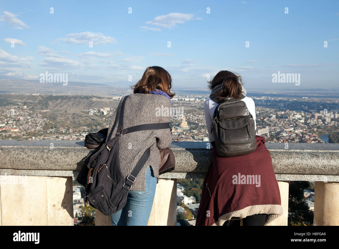 Two girls look with mountains on Tbilisi Stock Photo - Alamy