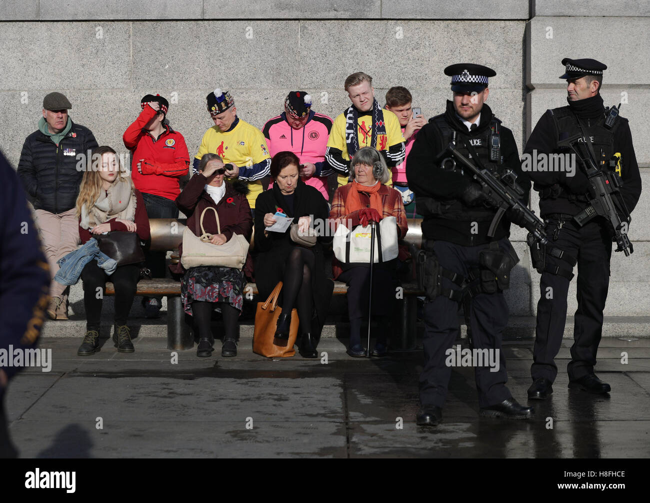 Armed police officers amongst Scottish football fans and members of the ...