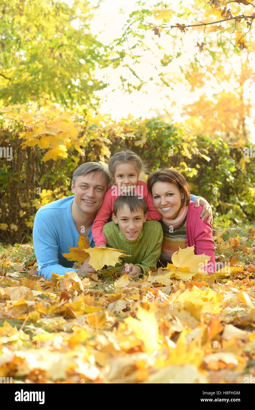 Happy family in autumn park Stock Photo - Alamy