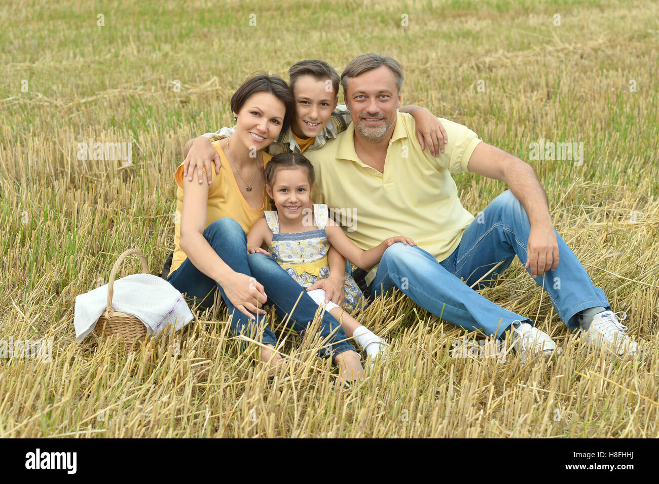 happy family at field Stock Photo - Alamy
