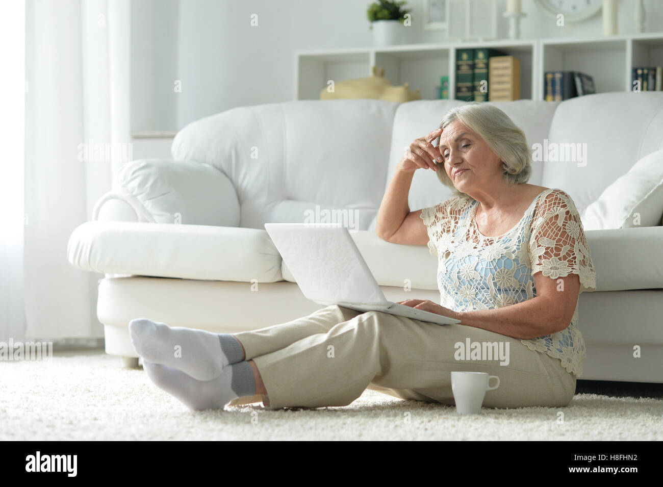 Senior woman with laptop Stock Photo - Alamy