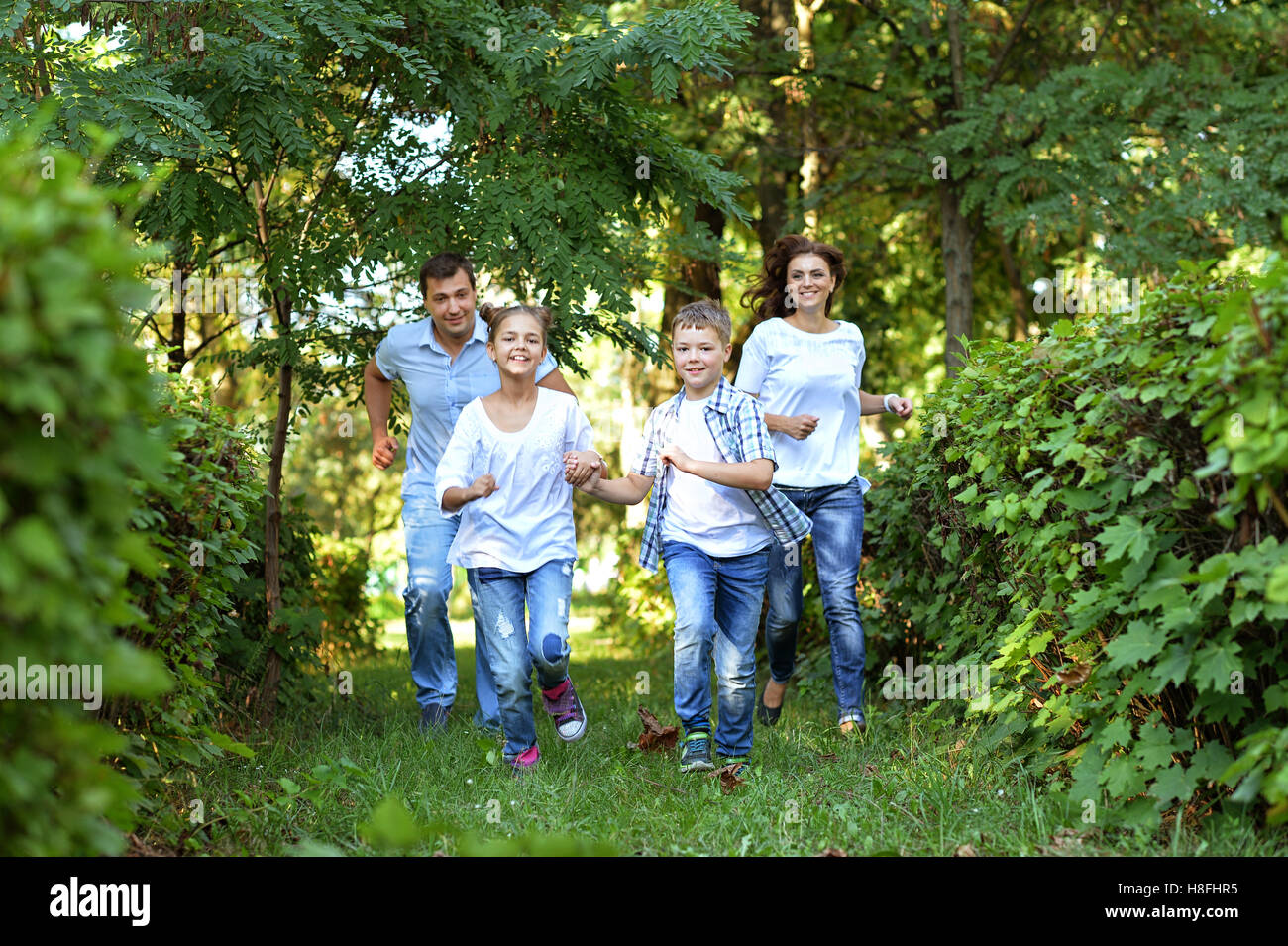 Happy family in park Stock Photo - Alamy