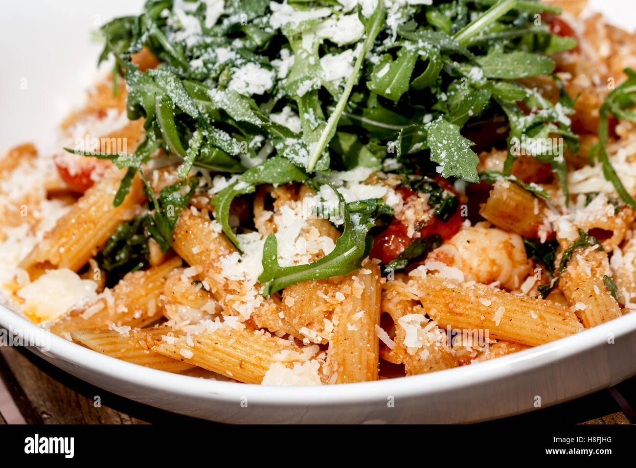Rigatoni with spicy rucola salad, shrimp and parmesan cheese Stock ...