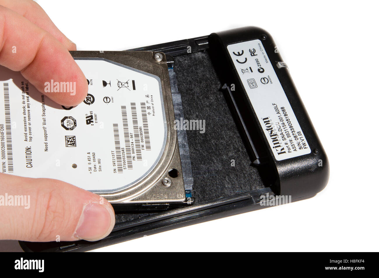 London, UK. Detail of person installing hard disk into external disk ...