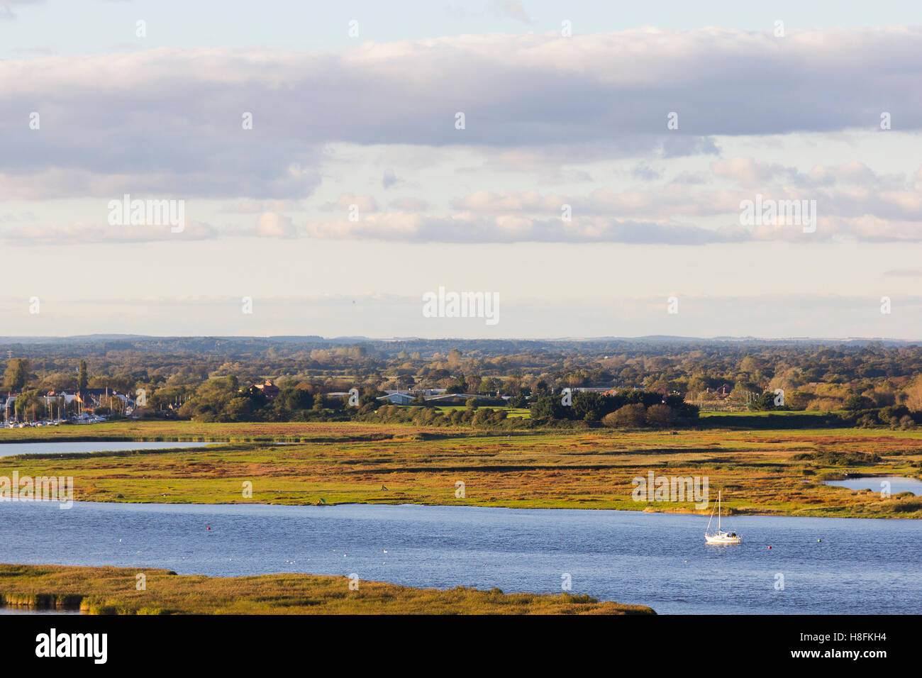 Hengistbury Head, Bournemouth, UK. Boat making its way along the River ...