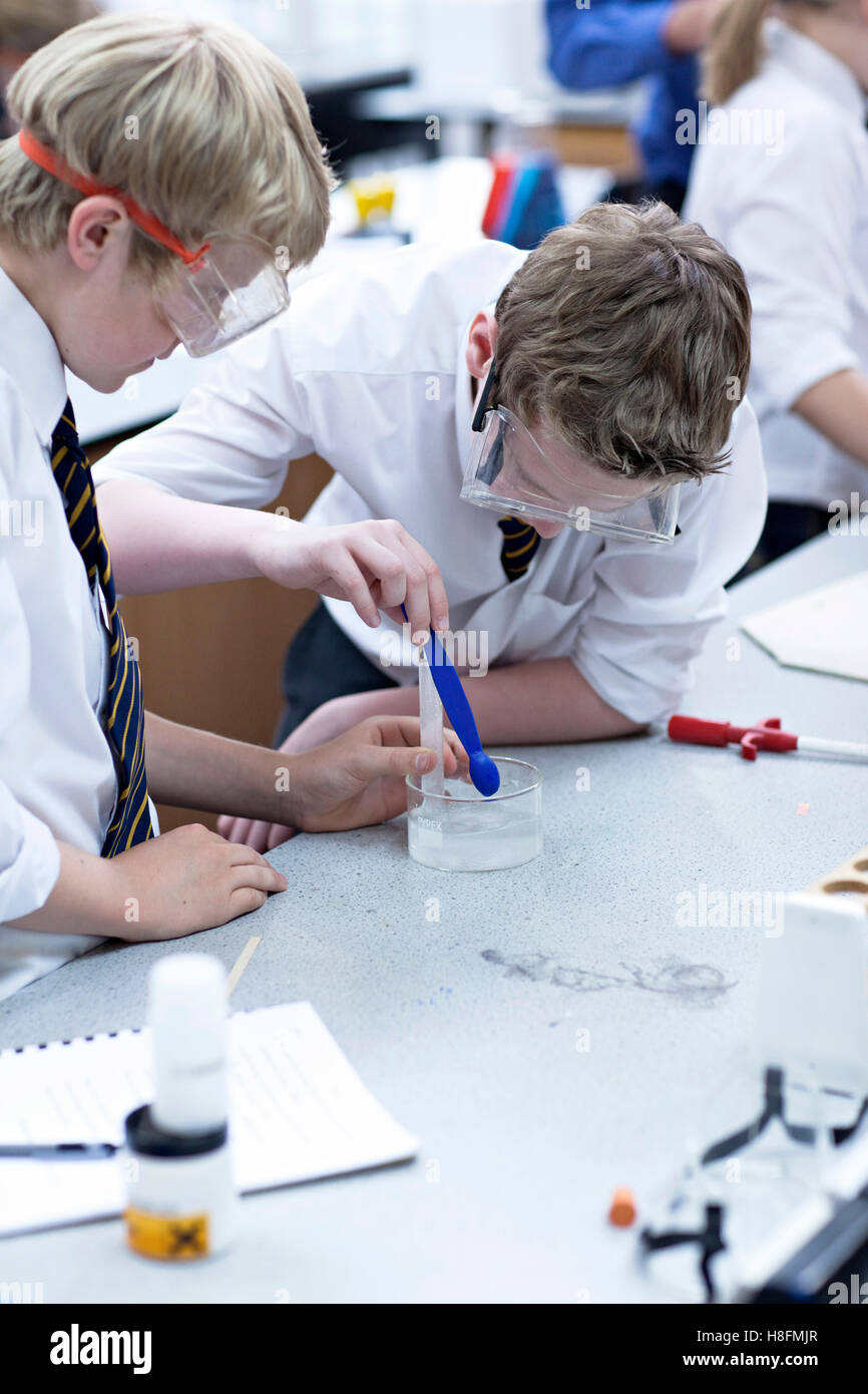 Two young school boys working on experiment in science class Stock ...