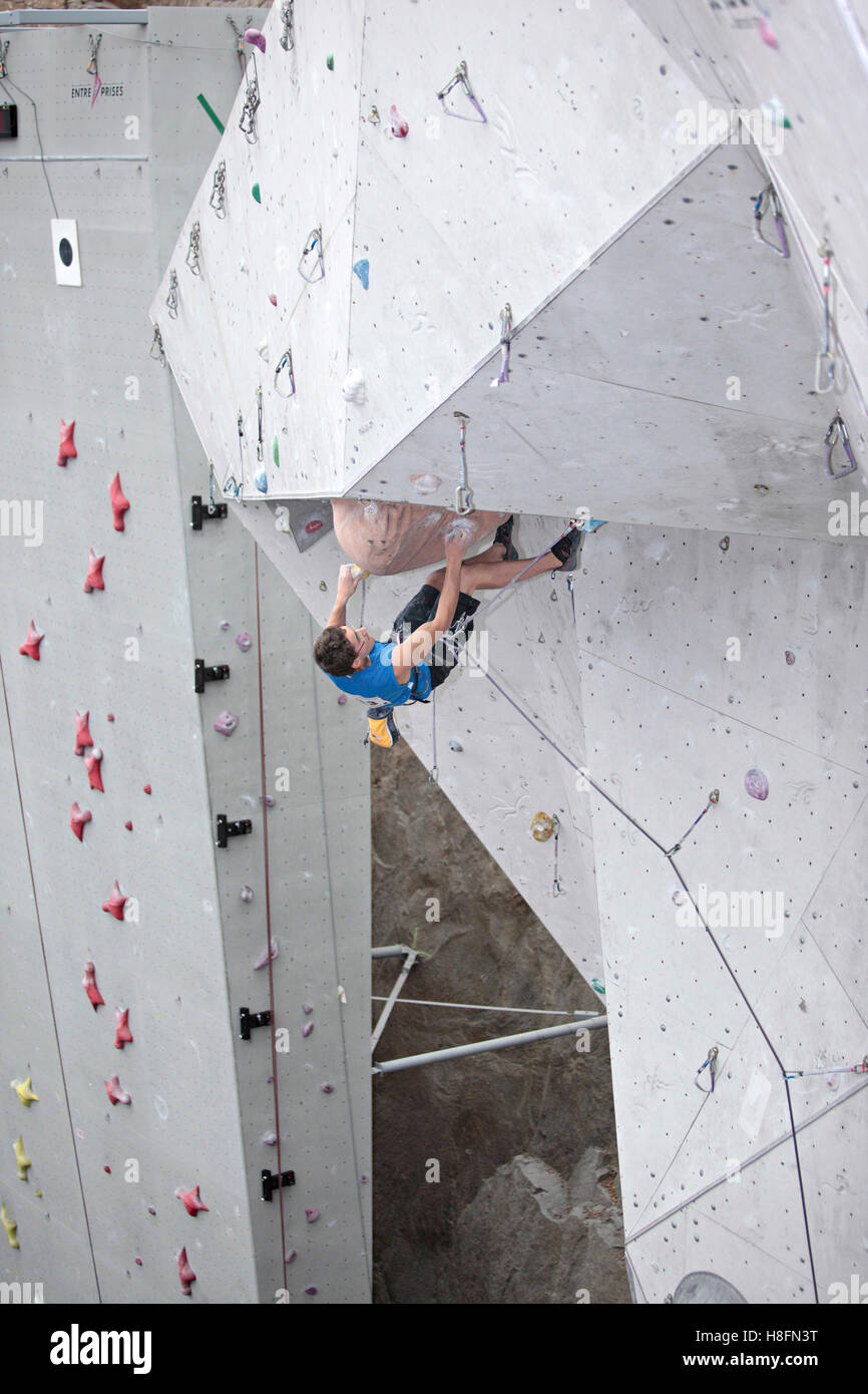 Young man climbing around overhang at Edinburgh climbing Arena EICA ...