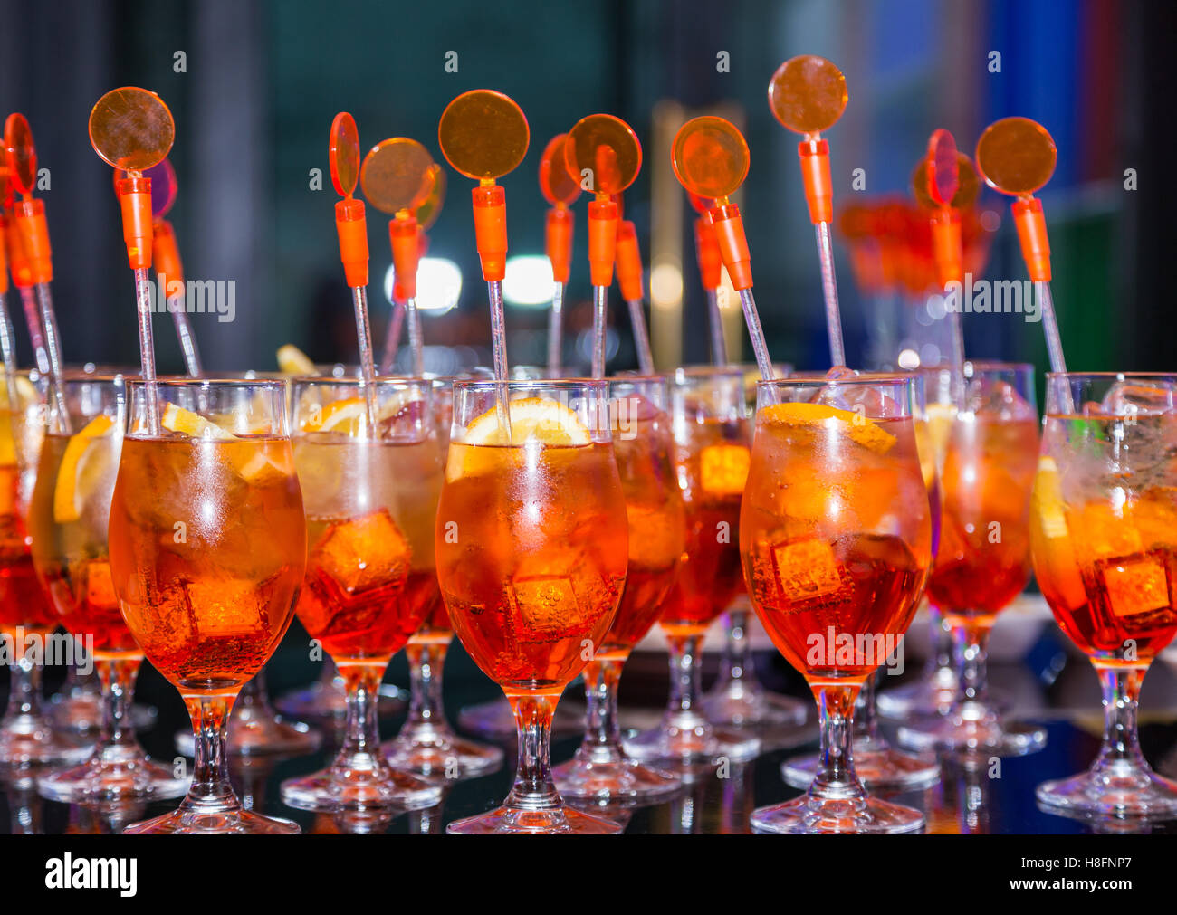 many orange cocktails on night party in dark room Stock Photo - Alamy