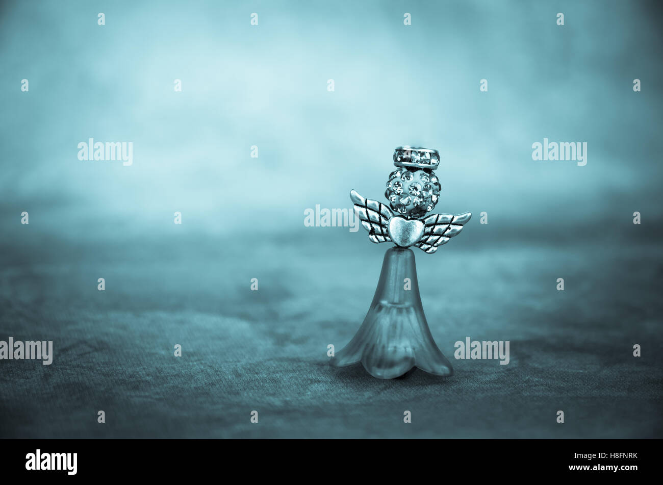 crystal angel decoration on blue background Stock Photo - Alamy