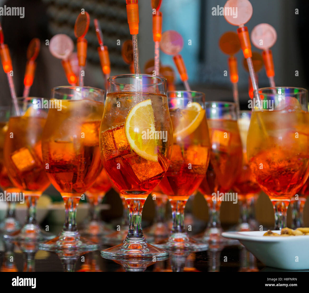 many orange cocktails on night party in dark room Stock Photo - Alamy