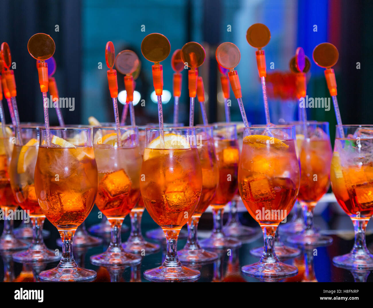 many orange cocktails on night party in dark room Stock Photo - Alamy