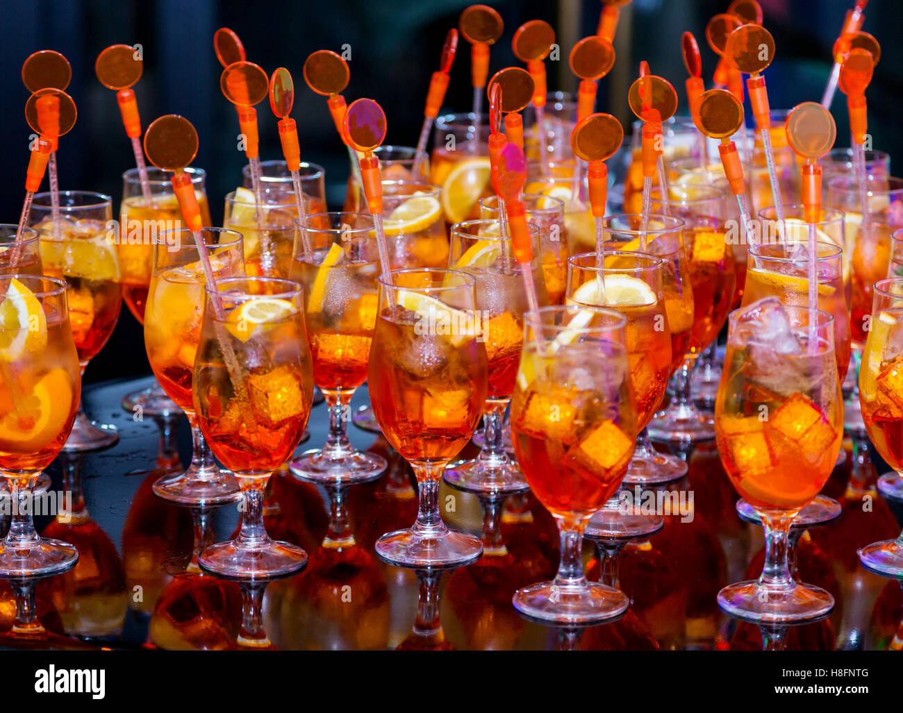 many orange cocktails on night party in dark room Stock Photo - Alamy