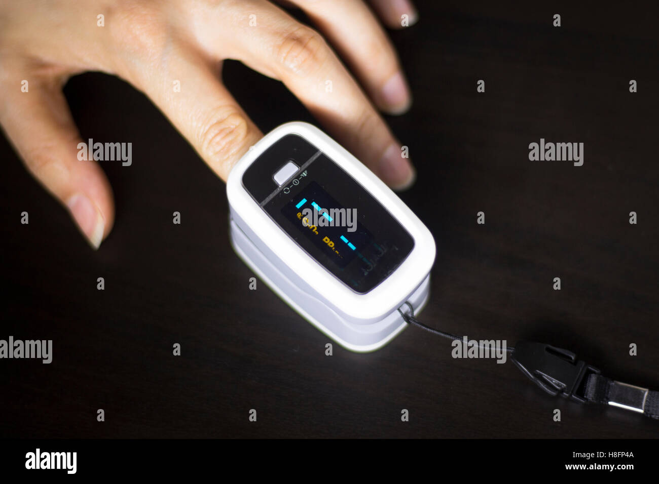 Portable hand held domestic cardiac finger pulse rate meter to show ...