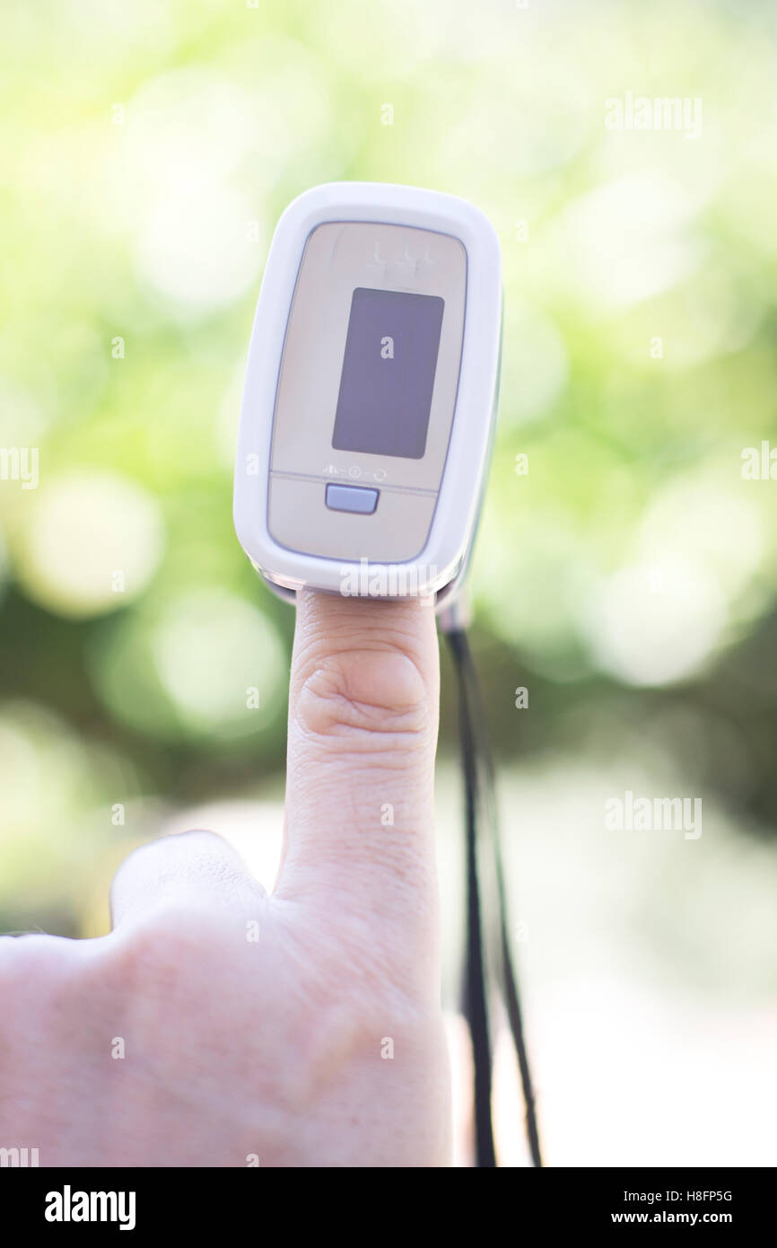 Portable hand held domestic cardiac finger pulse rate meter to show ...