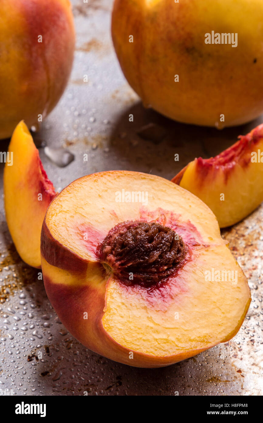 fresh juicy cut peach on steel plate Stock Photo - Alamy