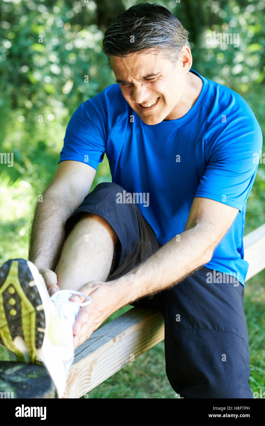 Man With Sports Injury Sustained Whilst Exercising Outdoors Stock Photo ...