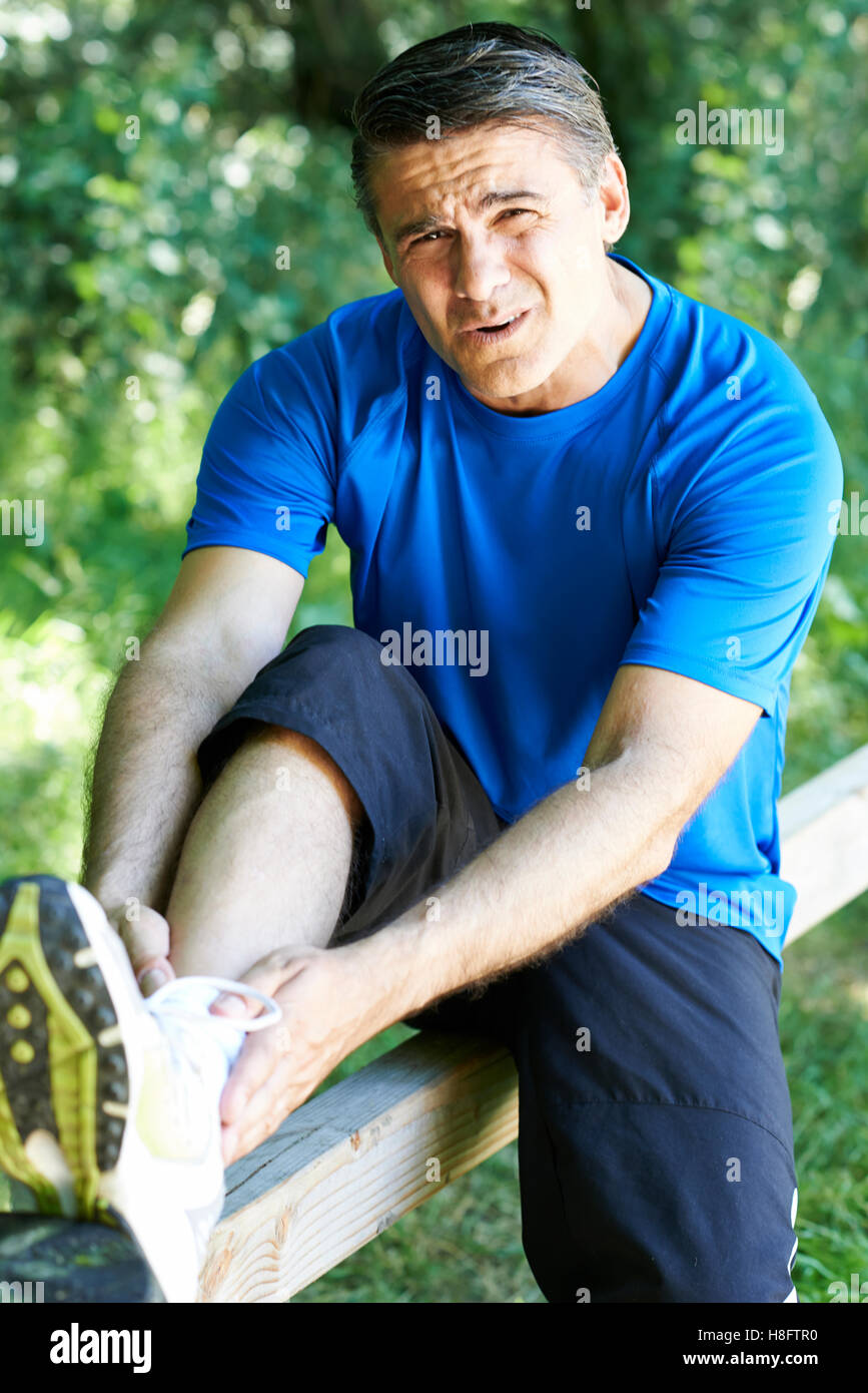 Man With Sports Injury Sustained Whilst Exercising Outdoors Stock Photo ...