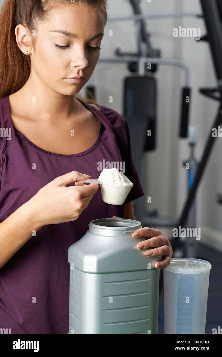 Young Woman In Gym Taking Nutritional Supplement Stock Photo - Alamy