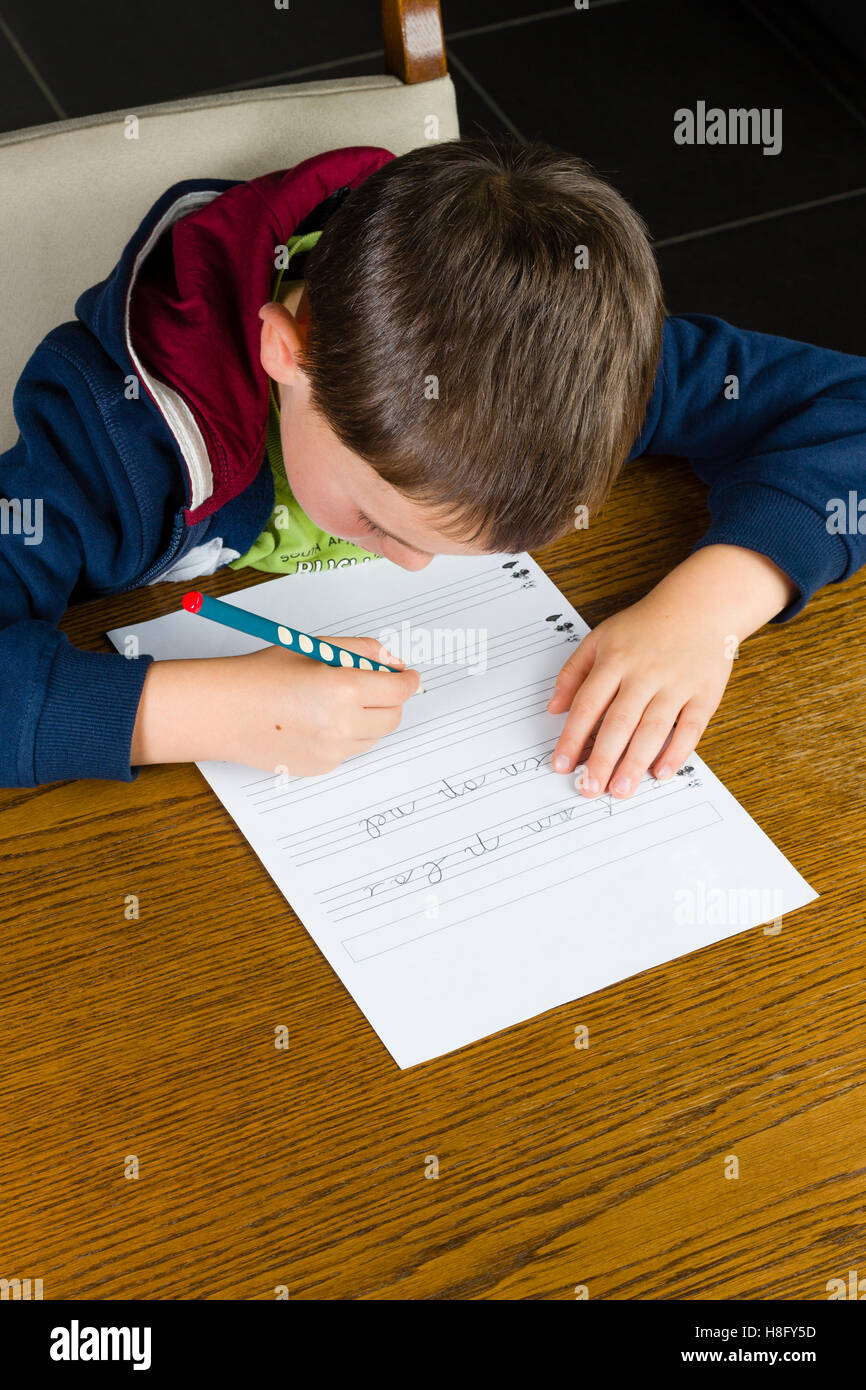 Young boy doing homework Stock Photo - Alamy