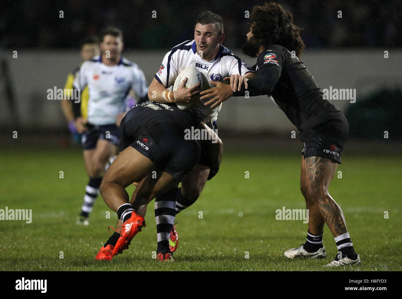 Scotland's Adam Walker is tackled by New Zealand's Manu Ma'u (left) and ...