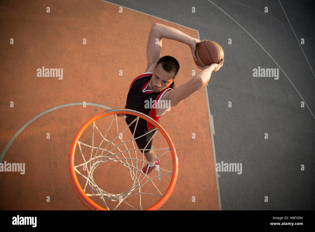 Basketball street player making a slam dunk Stock Photo - Alamy