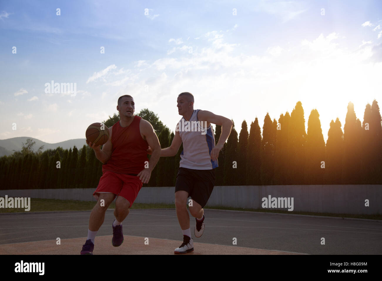 Two basketball players on the court outdoor Stock Photo - Alamy