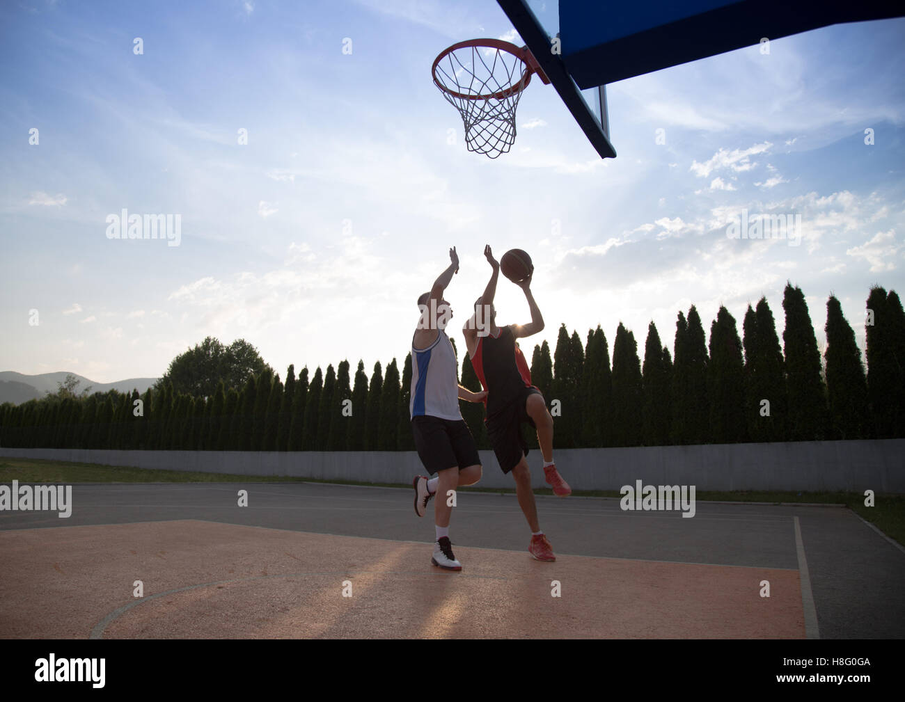 Two basketball players on the court outdoor Stock Photo - Alamy