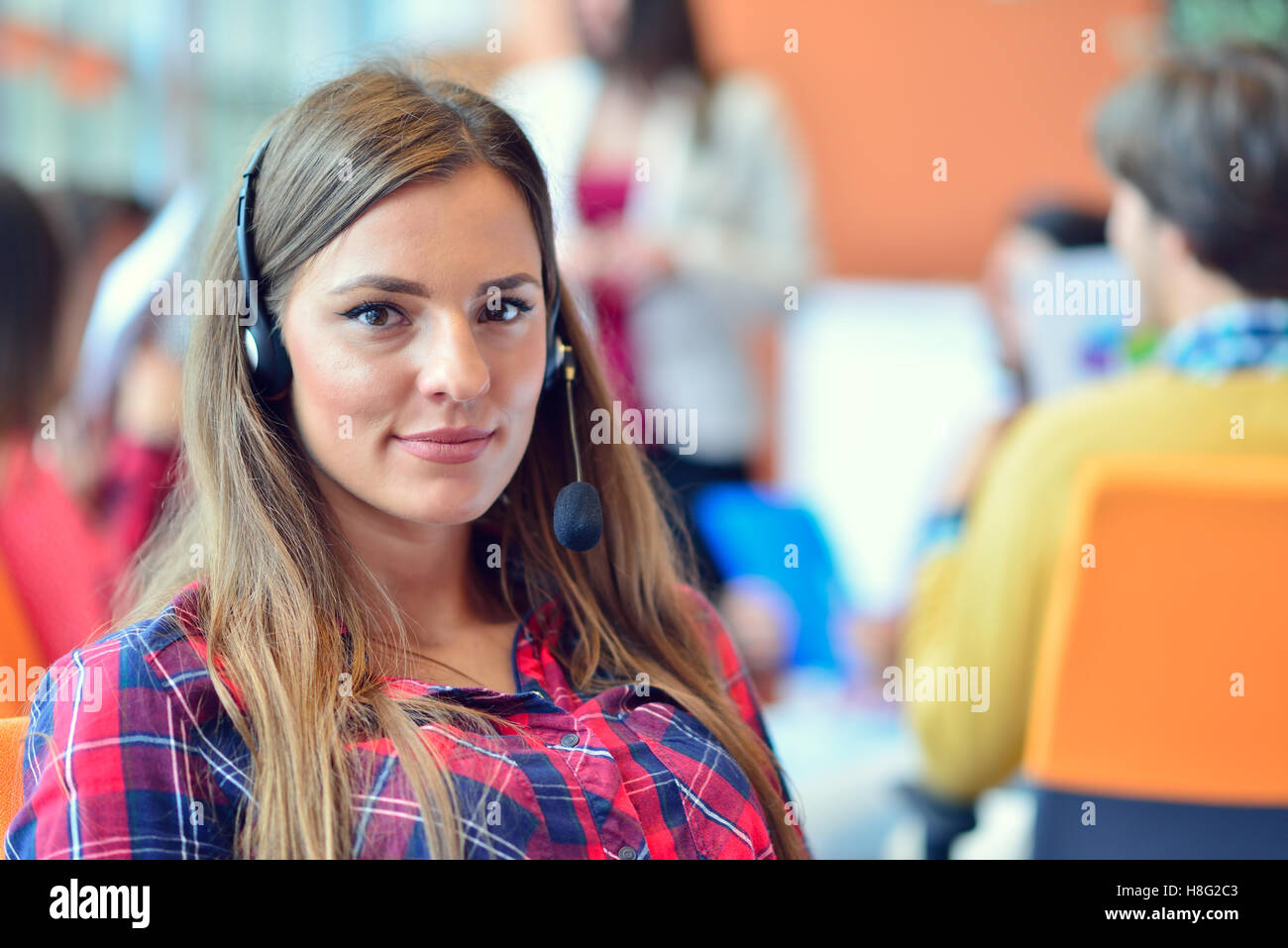 Cute businesswoman in an office with colleagues at the background Stock ...