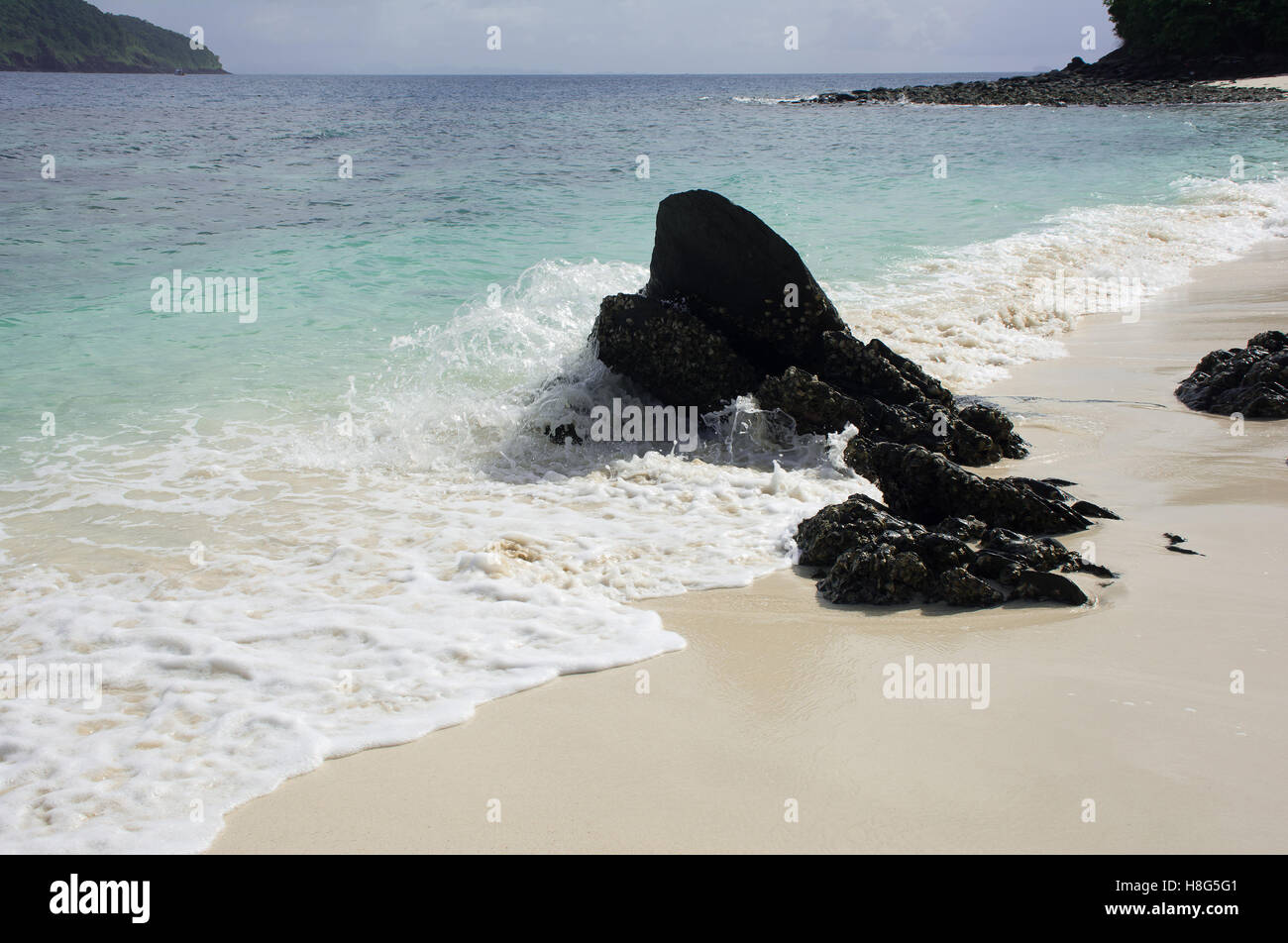 The coast of the Andaman ocean with the black rocks and The impact of ...