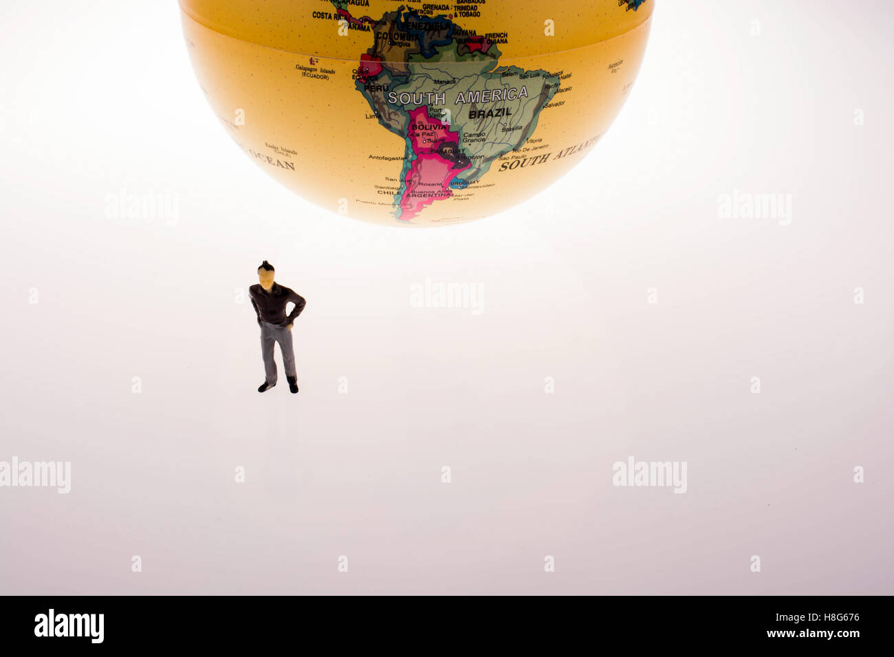 ittle model globe by the side of man figure Stock Photo - Alamy