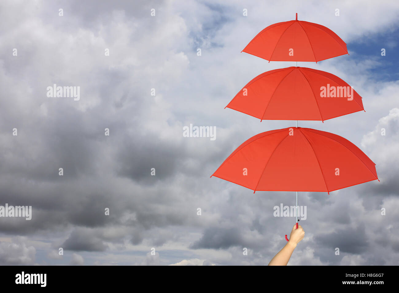 Red umbrella third layers in hand and rain protection more than,concept ...