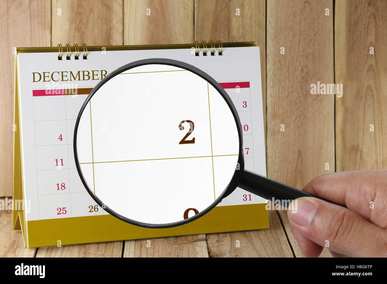 Magnifying glass in hand on calendar you can look two date of month ...