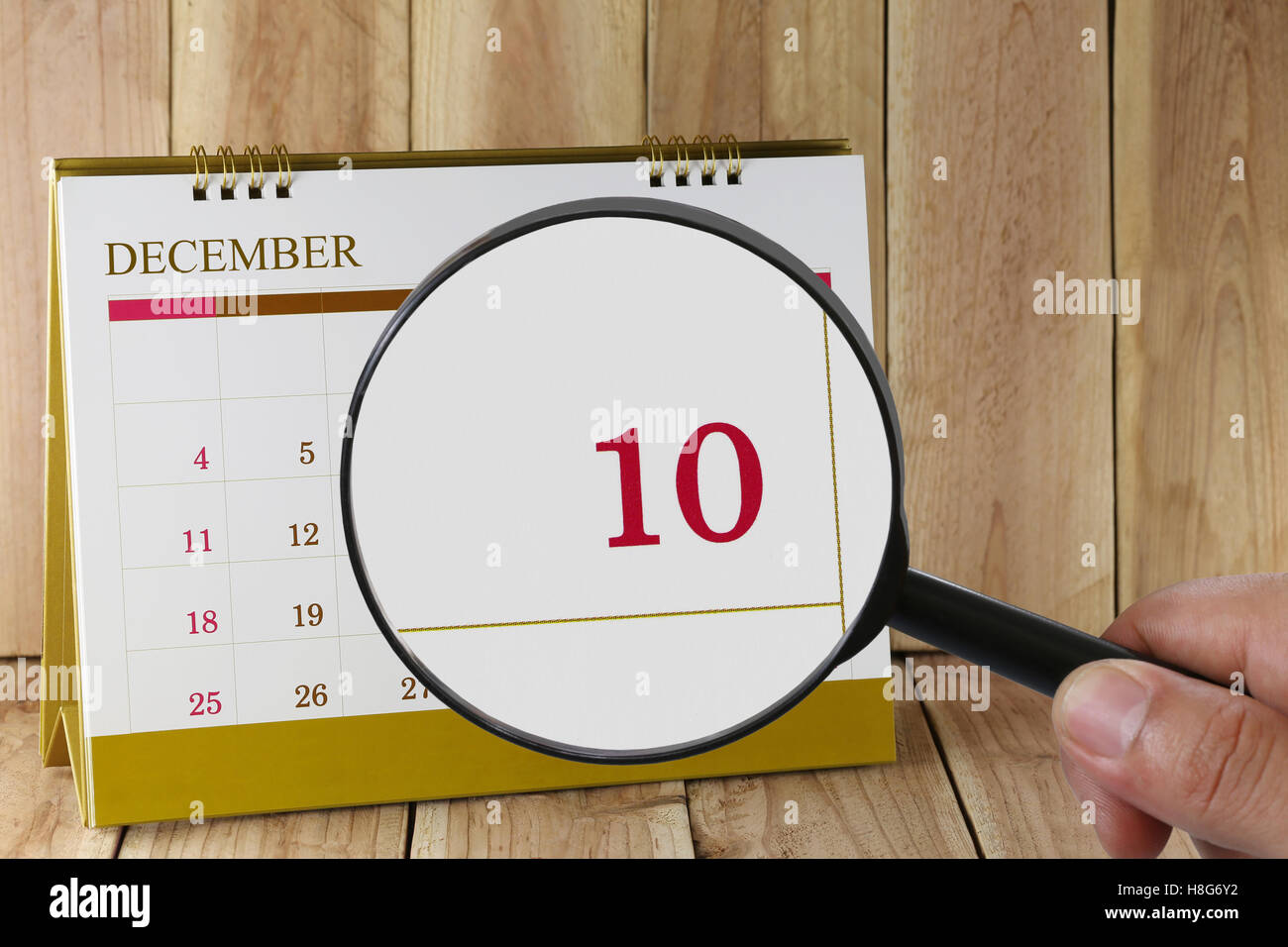 Magnifying glass in hand on calendar you can look tenth date of month ...