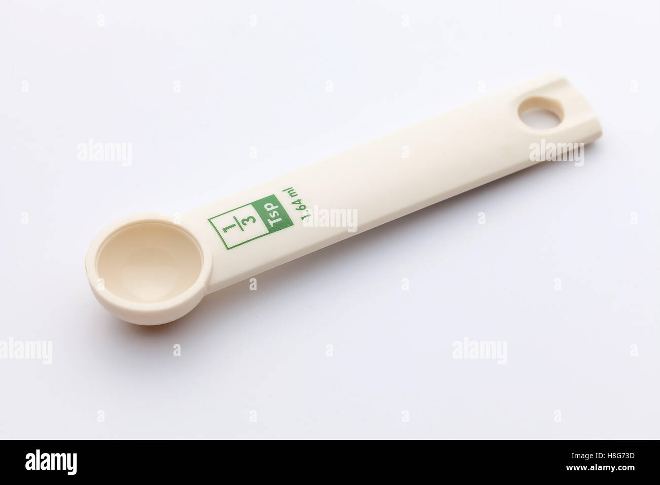 measuring spoon on white background kitchen object tool Stock Photo - Alamy